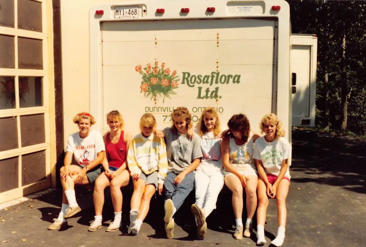 The crew takes a break sitting on a Rosa Flora truck bumper.